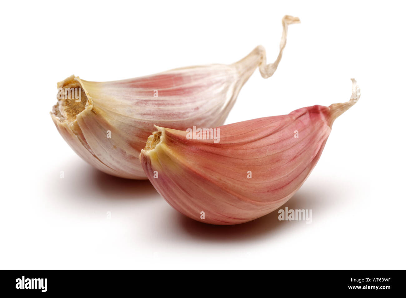 Two garlic cloves isolated on white background Stock Photo - Alamy