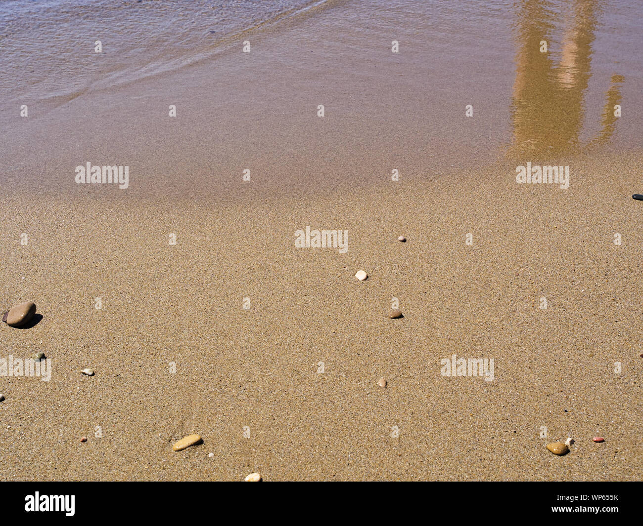 Human figure reflection on sandy beach surface Stock Photo - Alamy