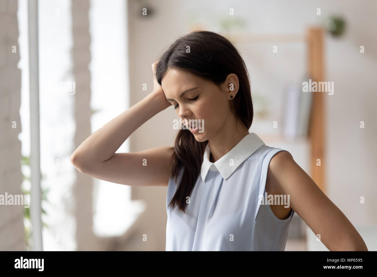 Unwell young woman touch head suffering from migraine Stock Photo - Alamy