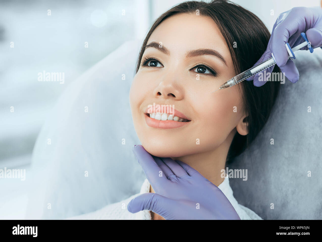 Korean woman getting rejuvenation injection for fresh skin. Staying ...