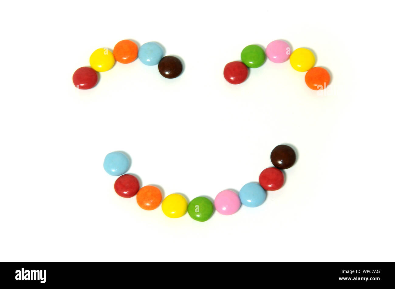 smiley colorful chocolate candy spread on white background Stock Photo ...