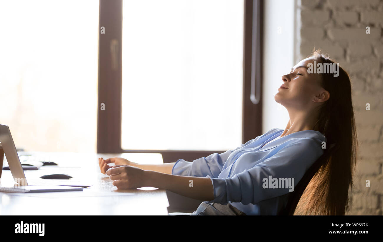Calm businesswoman relaxing in comfortable office chair at work Stock ...