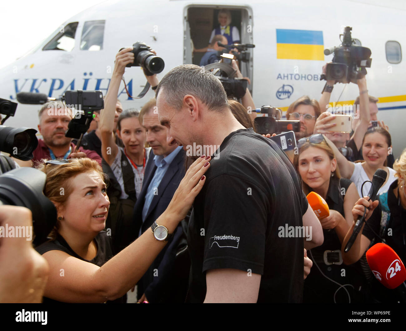 Ukrainian film director Oleg Sentsov (C) seen as a plane with recently ...