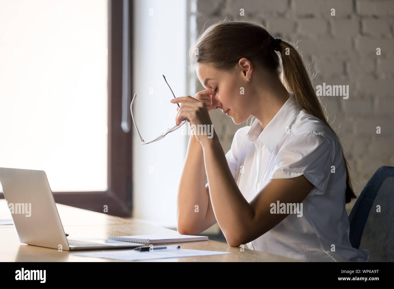 Woman taking off her glasses hi-res stock photography and images - Alamy