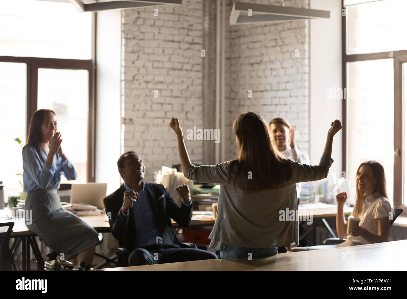 Diverse employees team with leader celebrating business success at ...