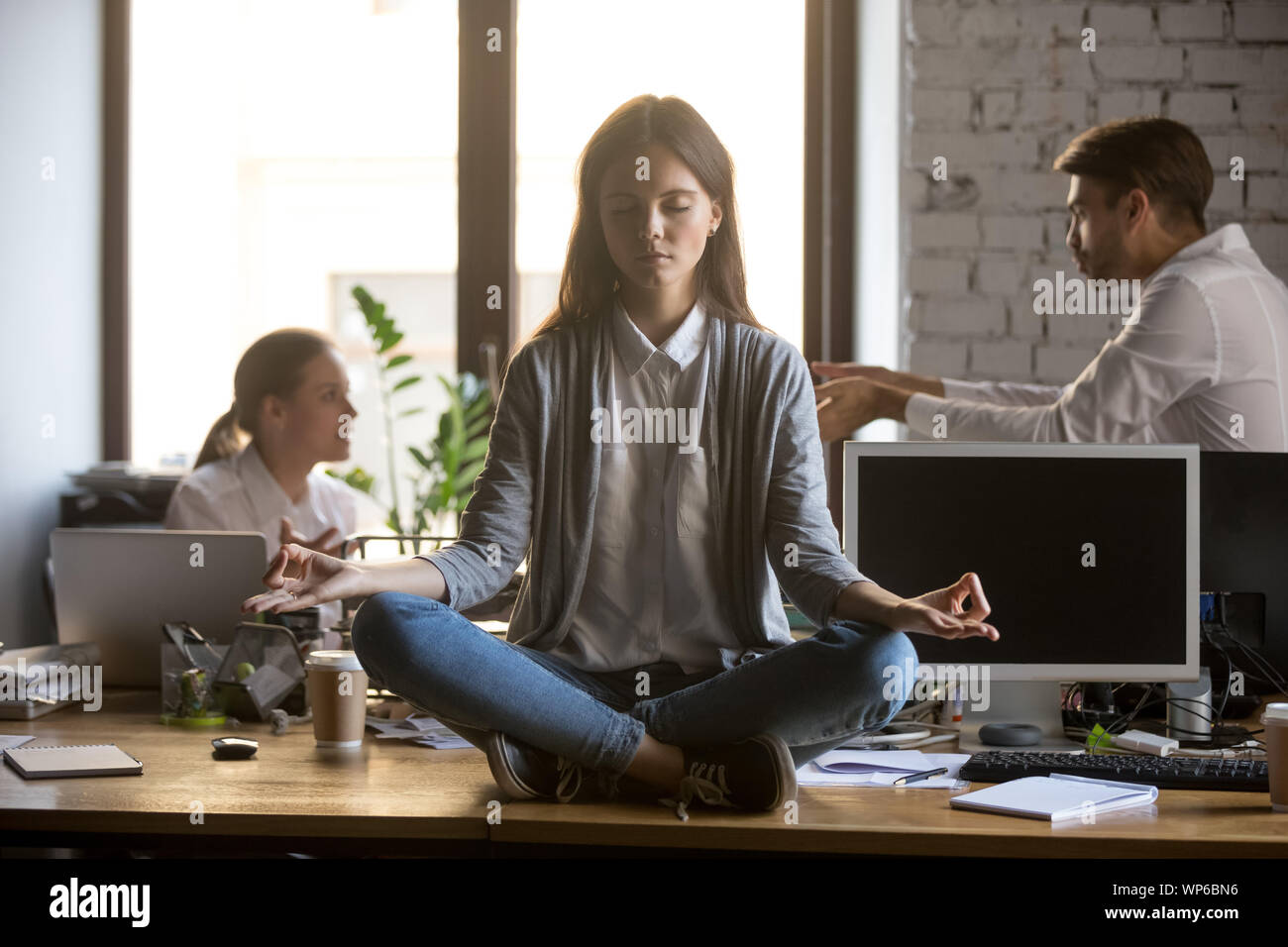 Businesswoman meditating at workplace, avoiding problem at work Stock ...