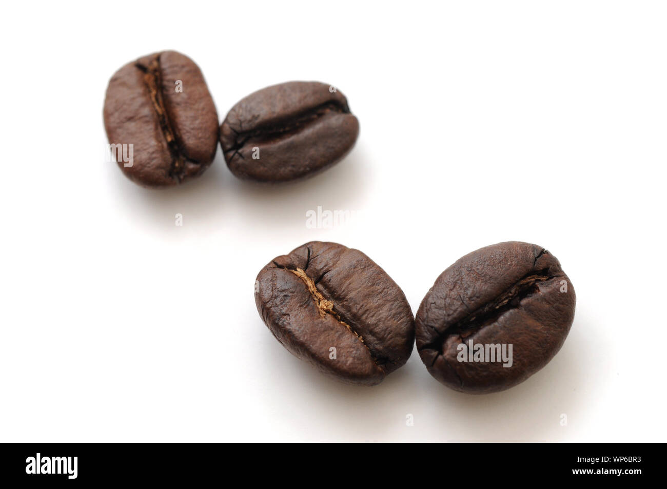 coffee beans closeup isolated on white background Stock Photo - Alamy