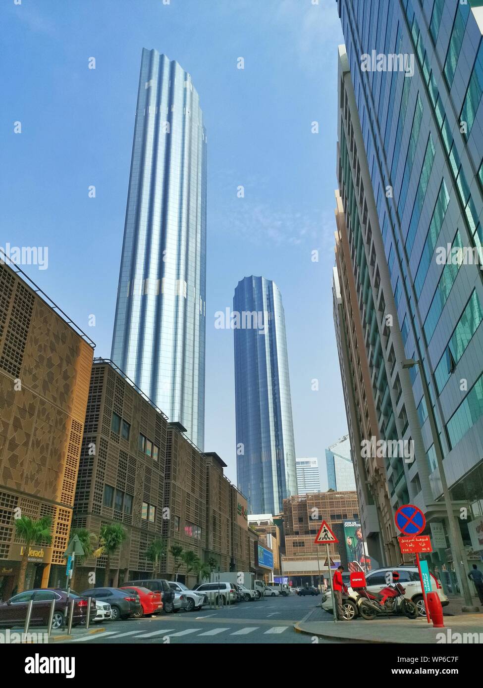 huge towers in the city skyscrapers blue next to short buildings Stock ...