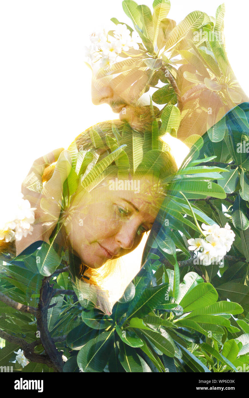 Double exposure of a couple with melancholic sad expression dissolving ...