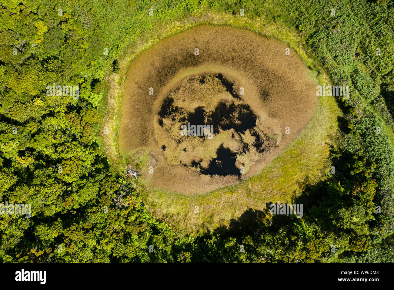 Aerial top view looking into a volcanic caldera crater lake at the ...