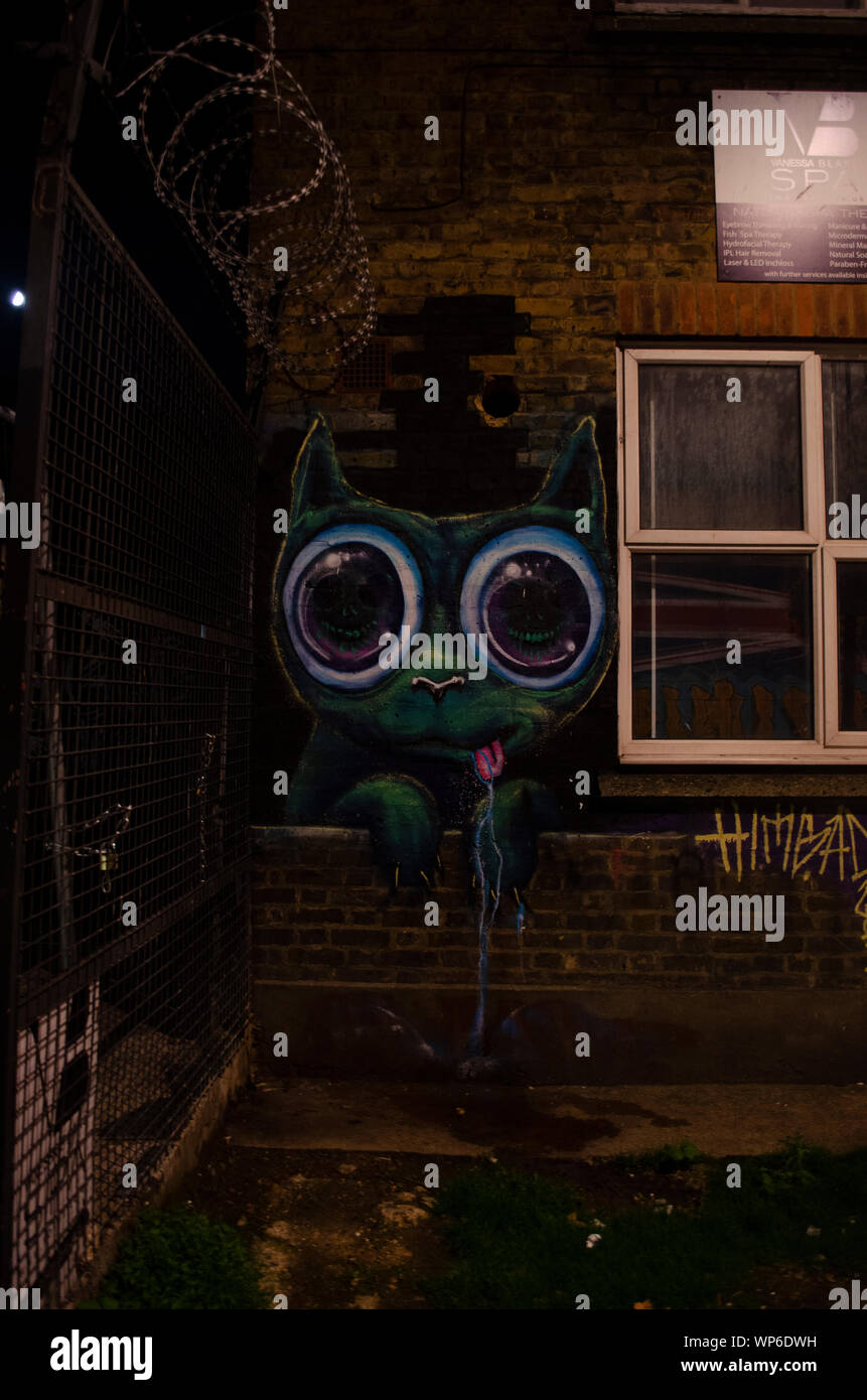 A cat like creature with big googly eyes drooling graffiti at Haven ...