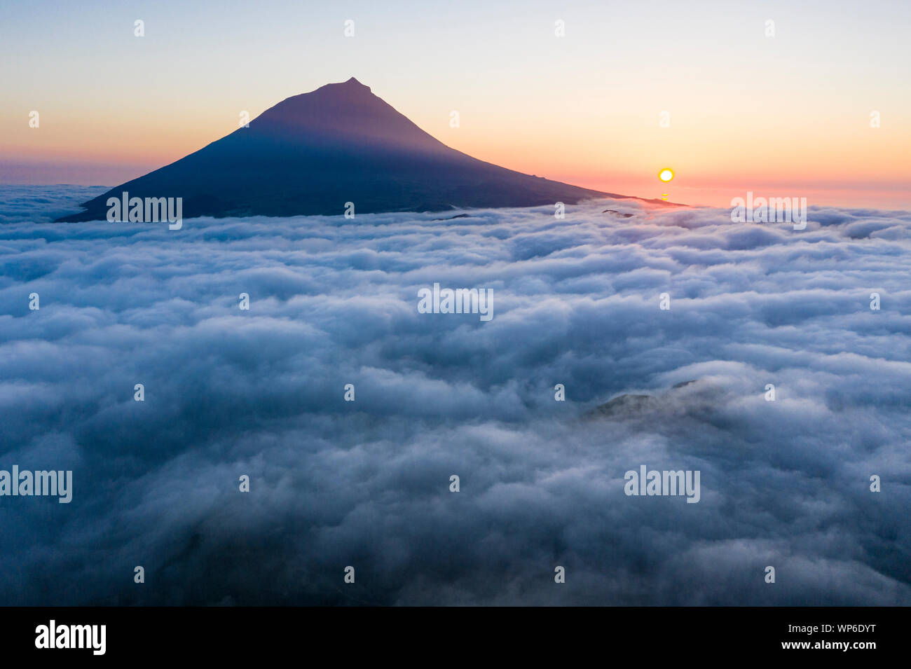 Aerial image with magical sunset over a low cloud layer covering Pico ...