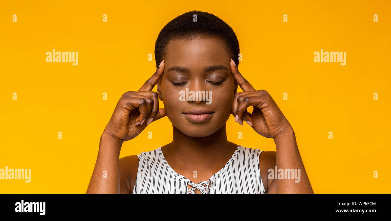 African american woman thinking hard with eyes closed Stock Photo - Alamy