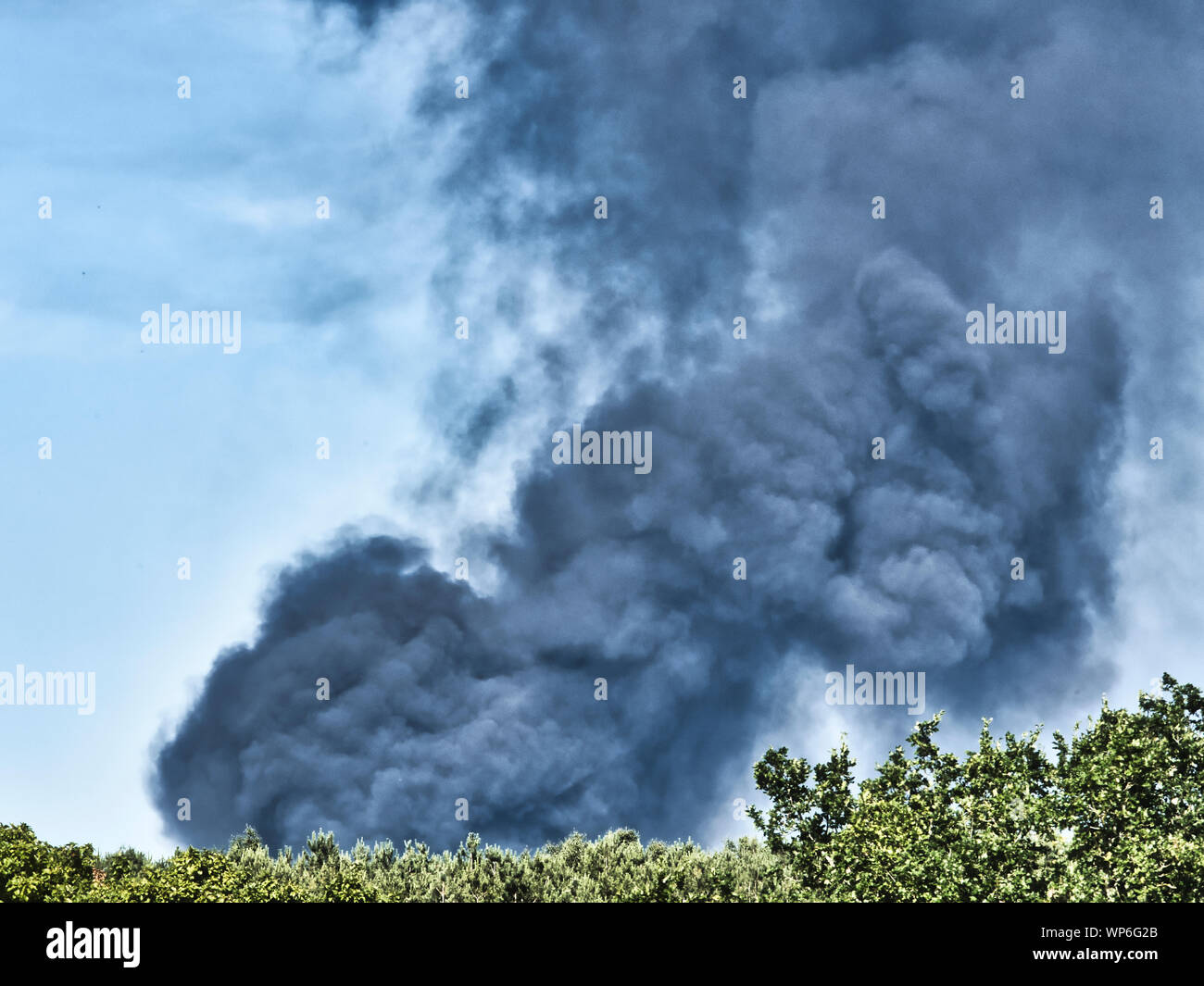 A Burning plastic recycling place causes a big pile of dark, black ...