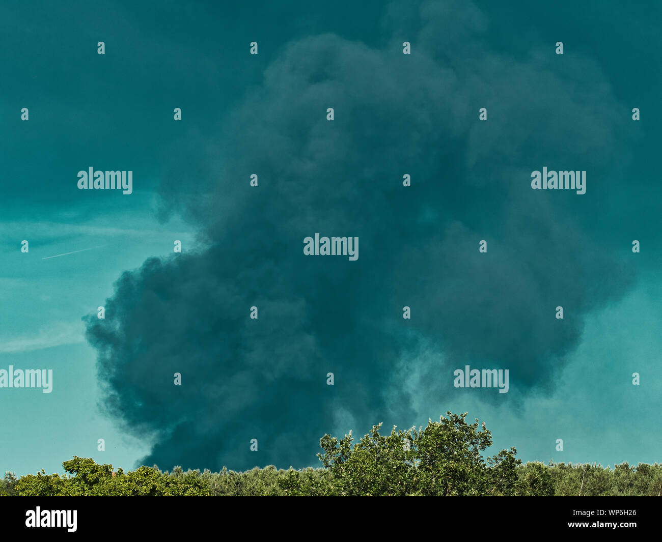 A Burning plastic recycling place causes a big pile of dark, black ...