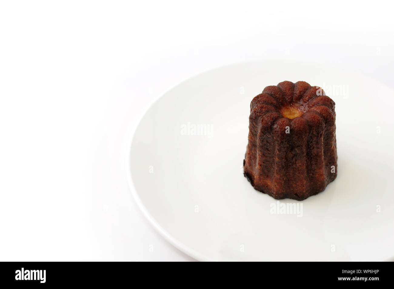 canele de Bordeaux on plate french pastry closeup isolated on white ...