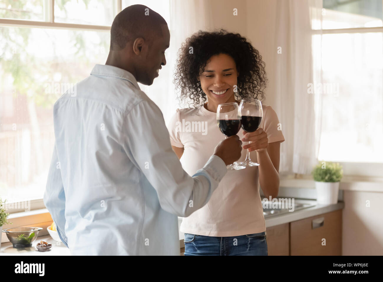 Loving Biracial Couple Clink Glasses Celebrating Having Date Stock
