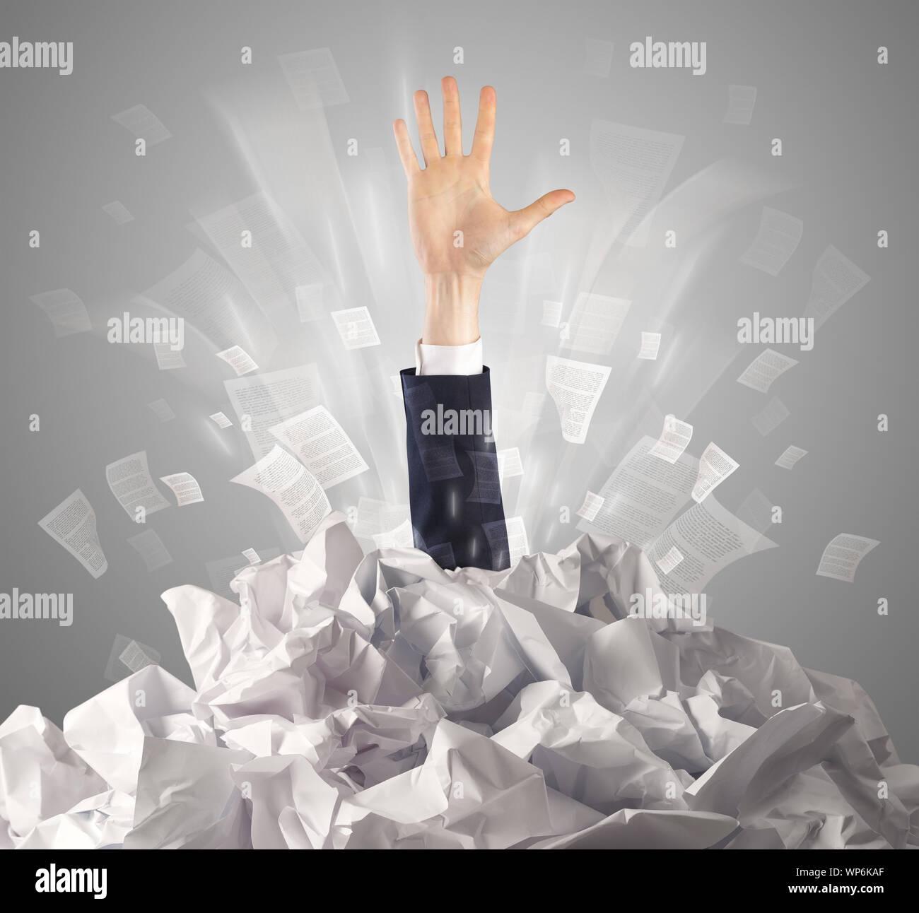 Hand coming out from a huge paper pile Stock Photo - Alamy