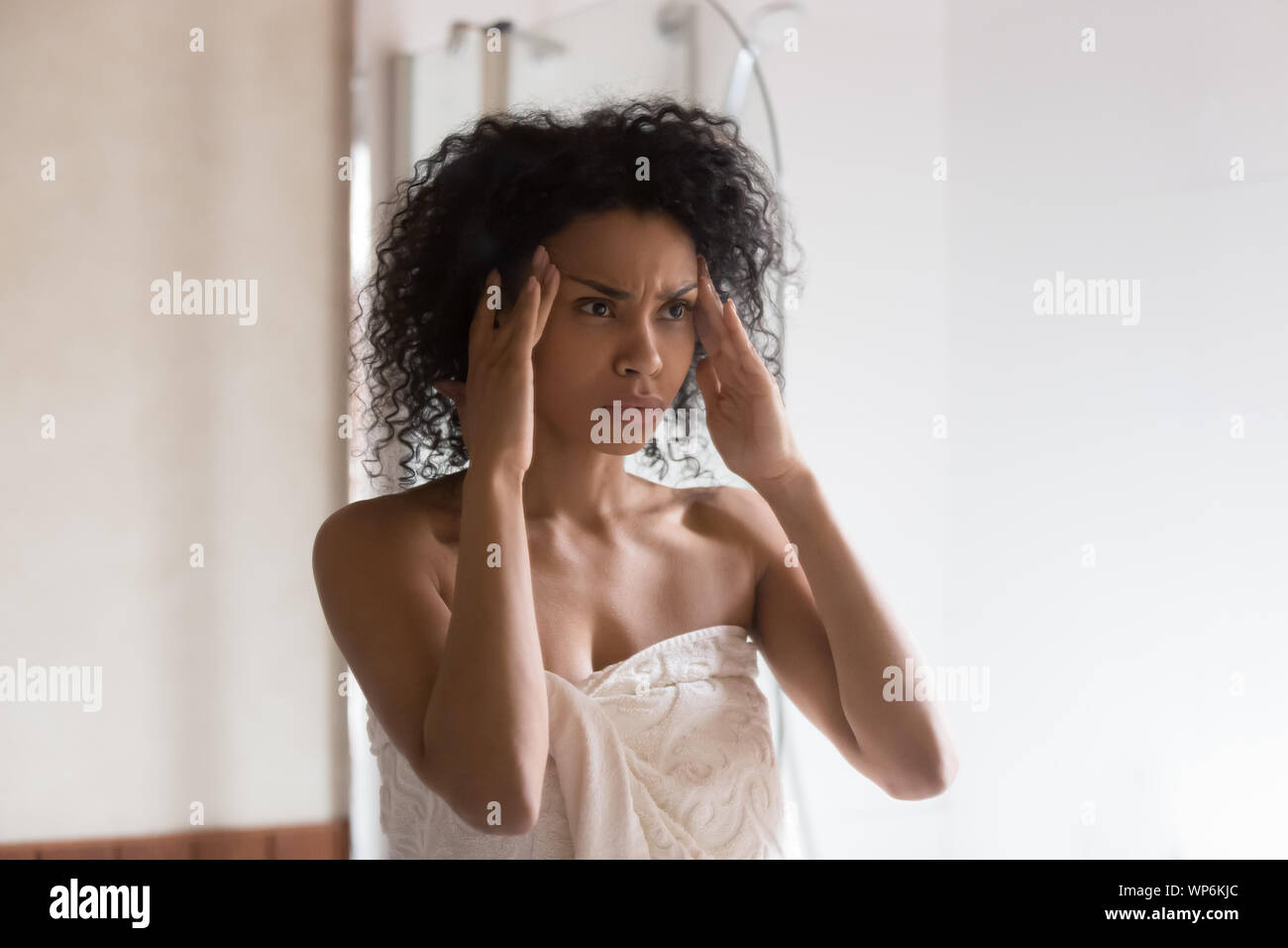 Anxious african American woman worried about face wrinkles Stock Photo ... Anxious african American woman worried about face wrinkles Stock Photo ...
