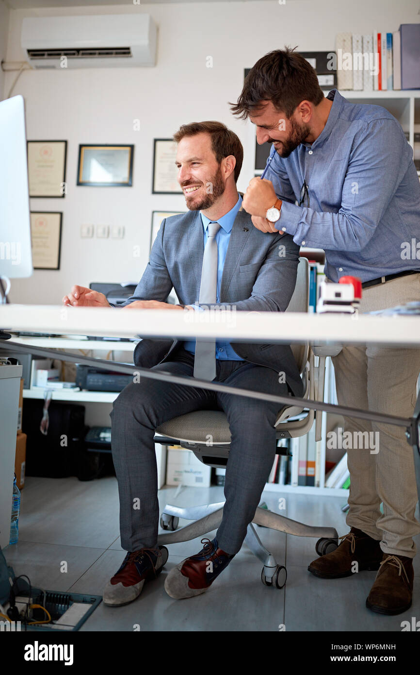 Team of successful business men in a meeting at work Stock Photo - Alamy
