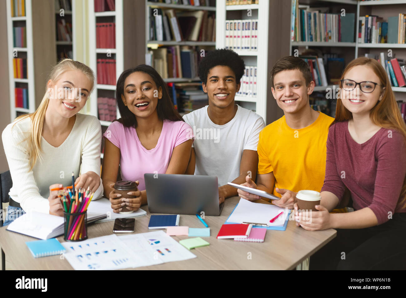 Group of international studying teenagers smiling at camera Stock Photo ...