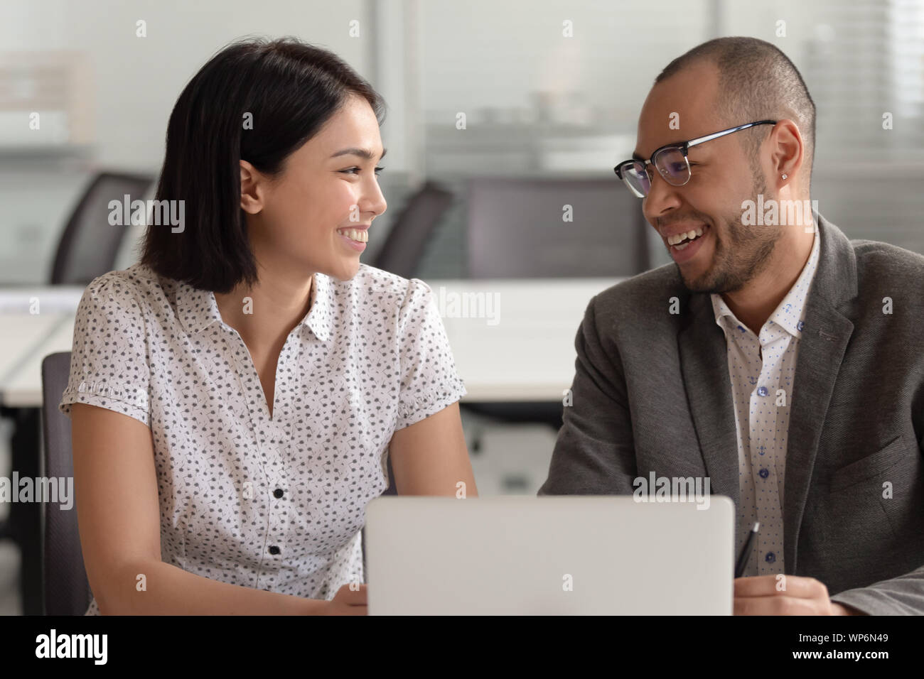 Happy mixed race employees working together at office Stock Photo - Alamy