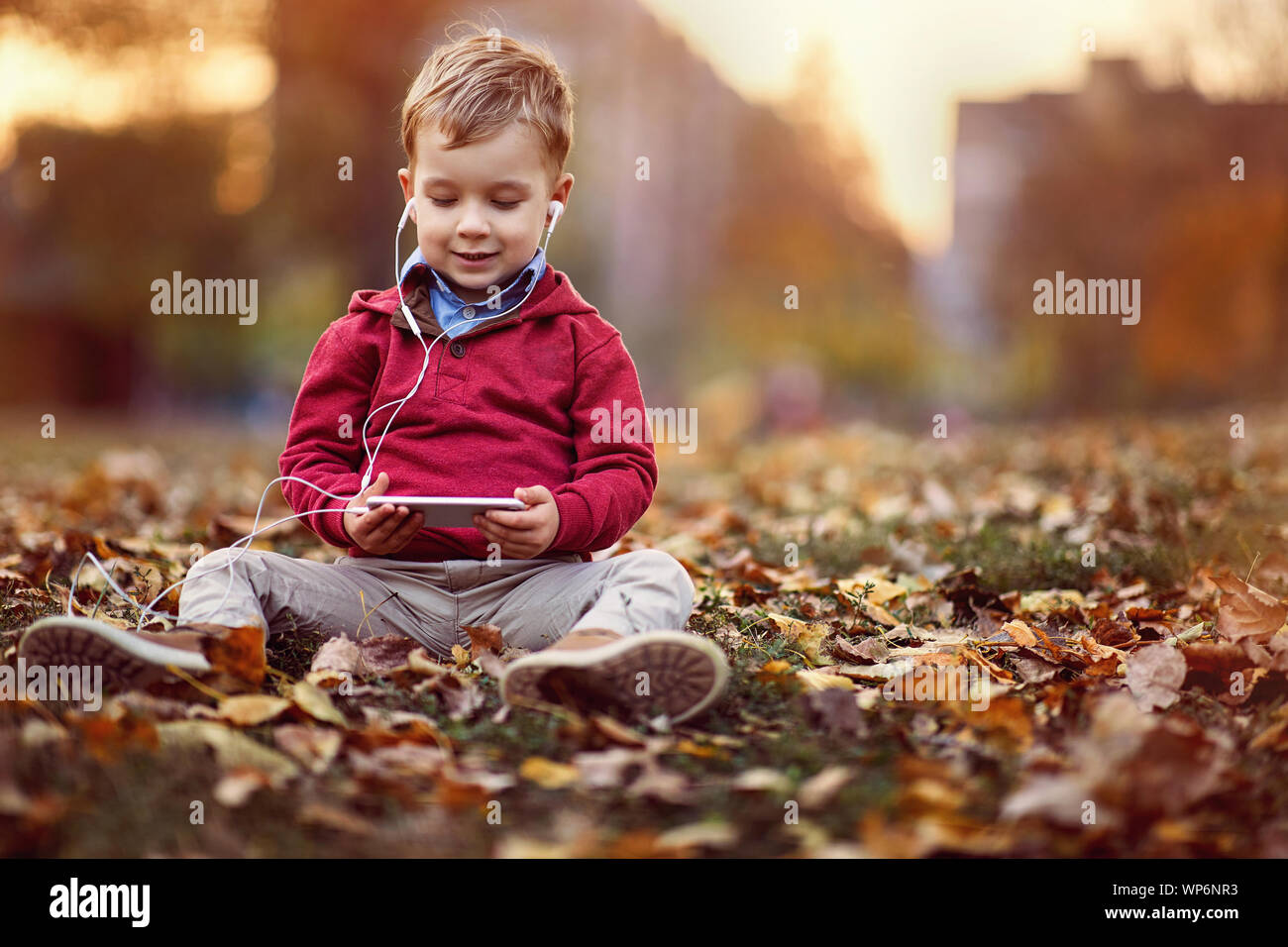 happy boy listen music on smartphone outdoors Stock Photo - Alamy