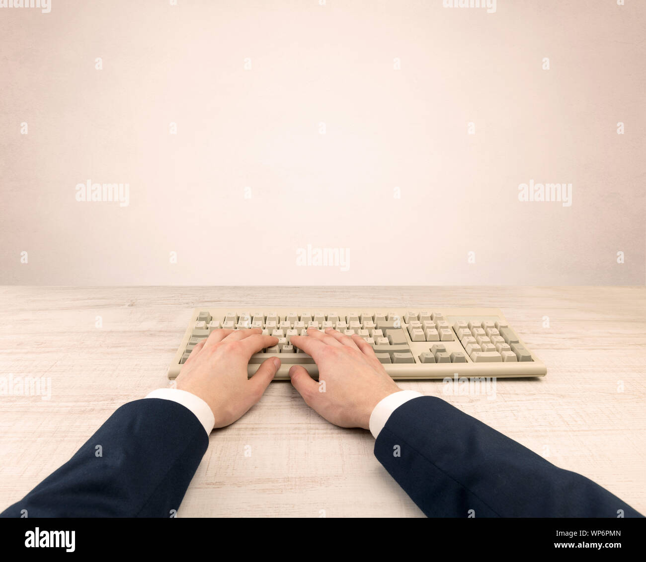 First person view of an elegant businessman hand typing on light ...