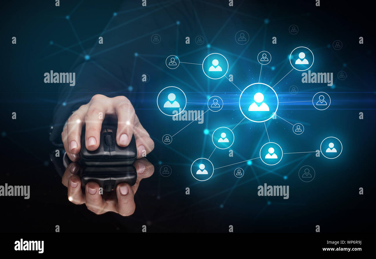 Hand using wireless mouse in a dark environment with human network ...