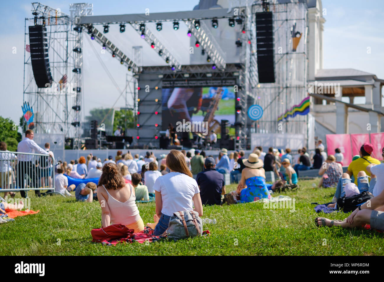 Girls friends watching concert at open air music festival, back view ...