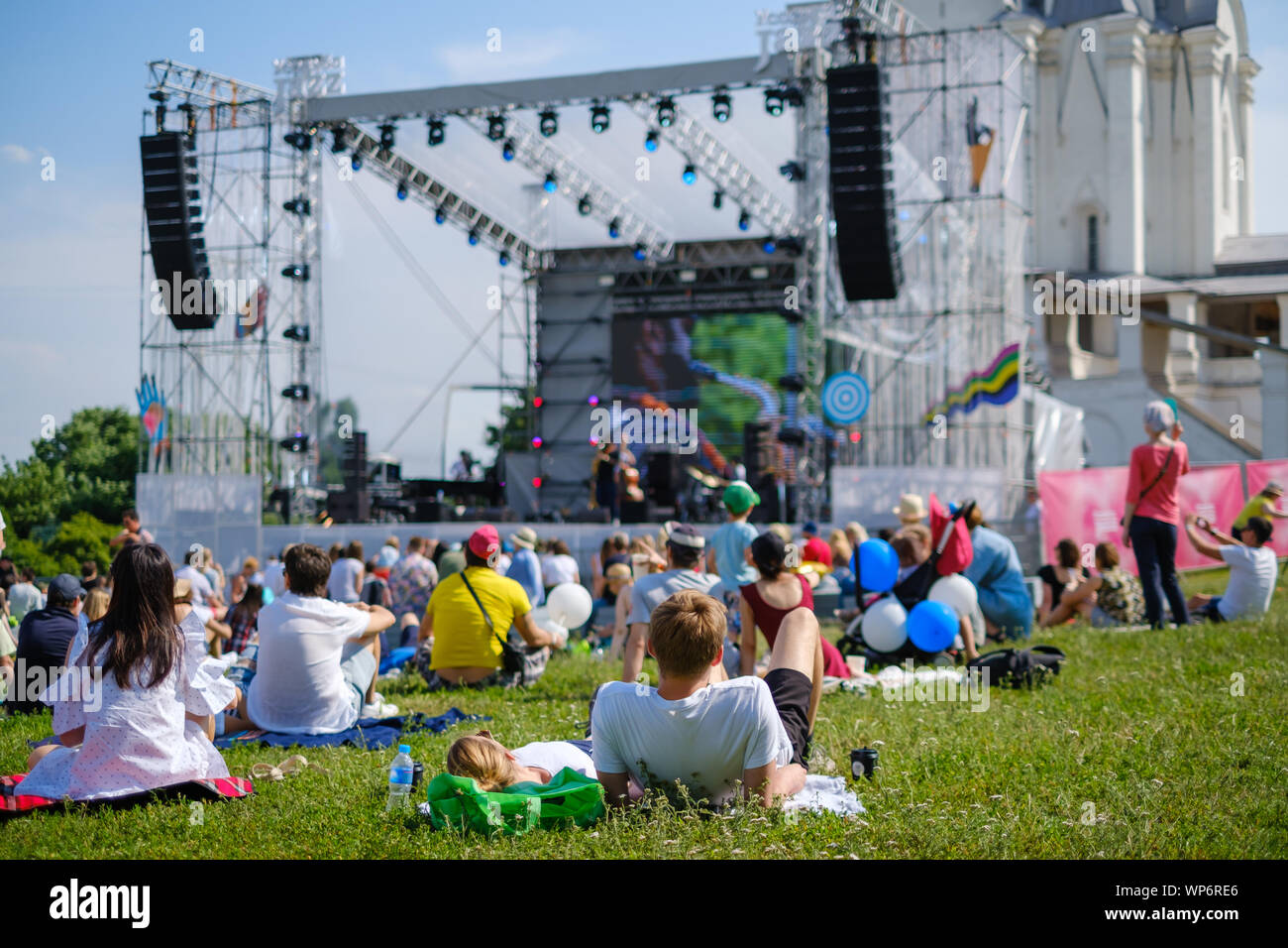 Couple watching concert at open air music festival, back view, stage ...