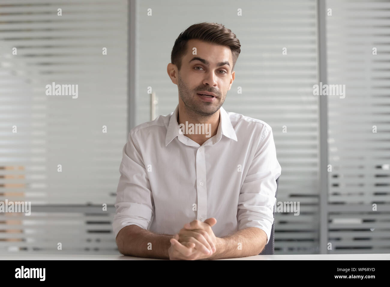 Concentrated male hr manager holding video distant job interview Stock ...