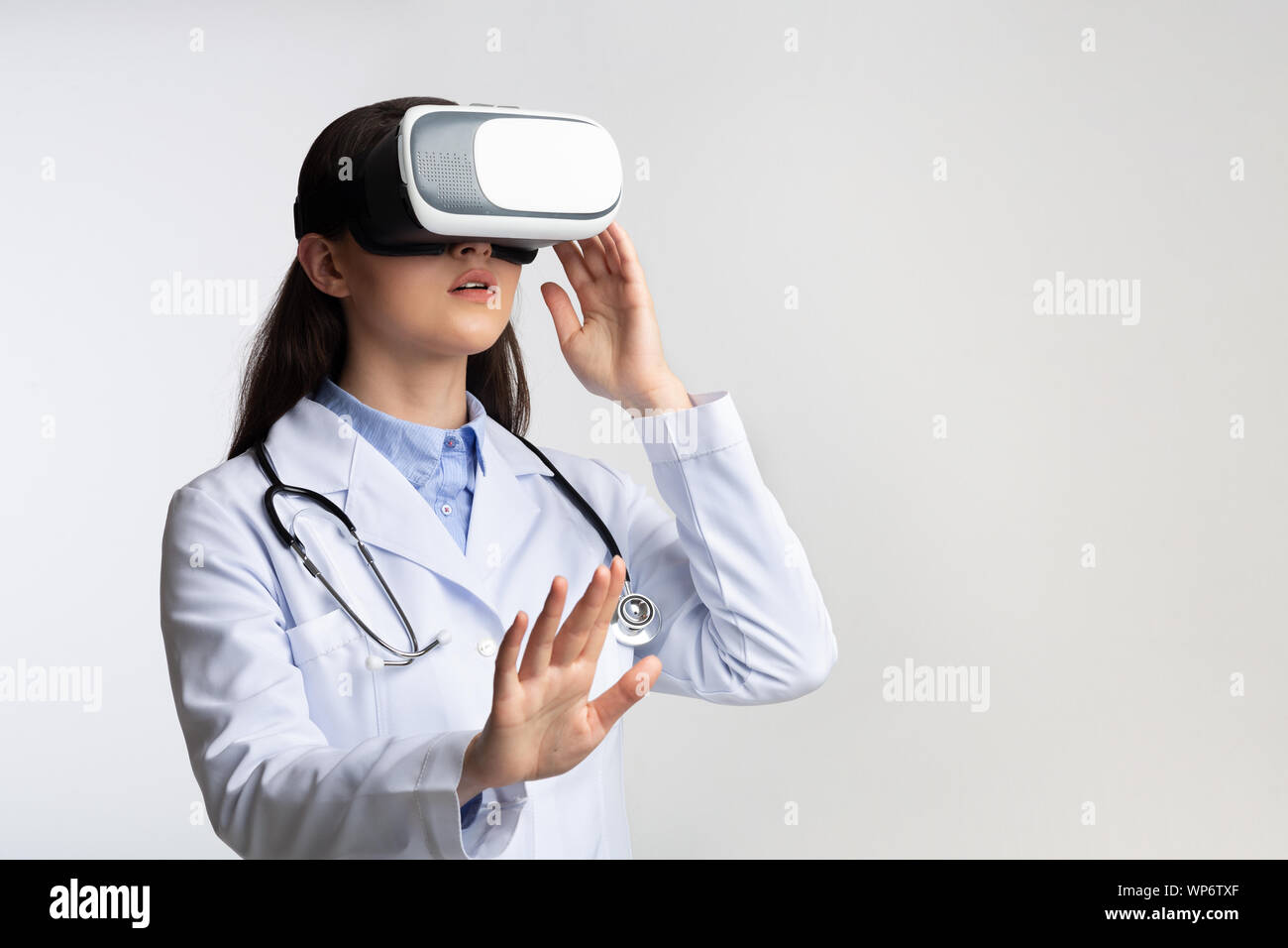 Female Doctor Wearing VR Glasses Over White Background Stock Photo - Alamy