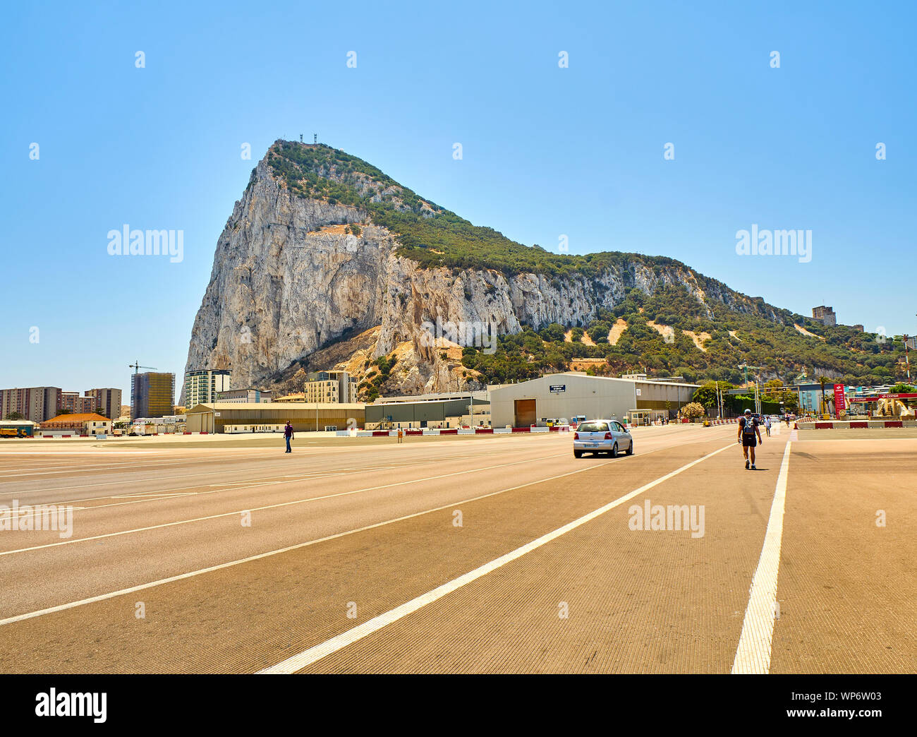 Gibraltar, UK - June 29, 2019. Locals and cars crossing the runway at ...