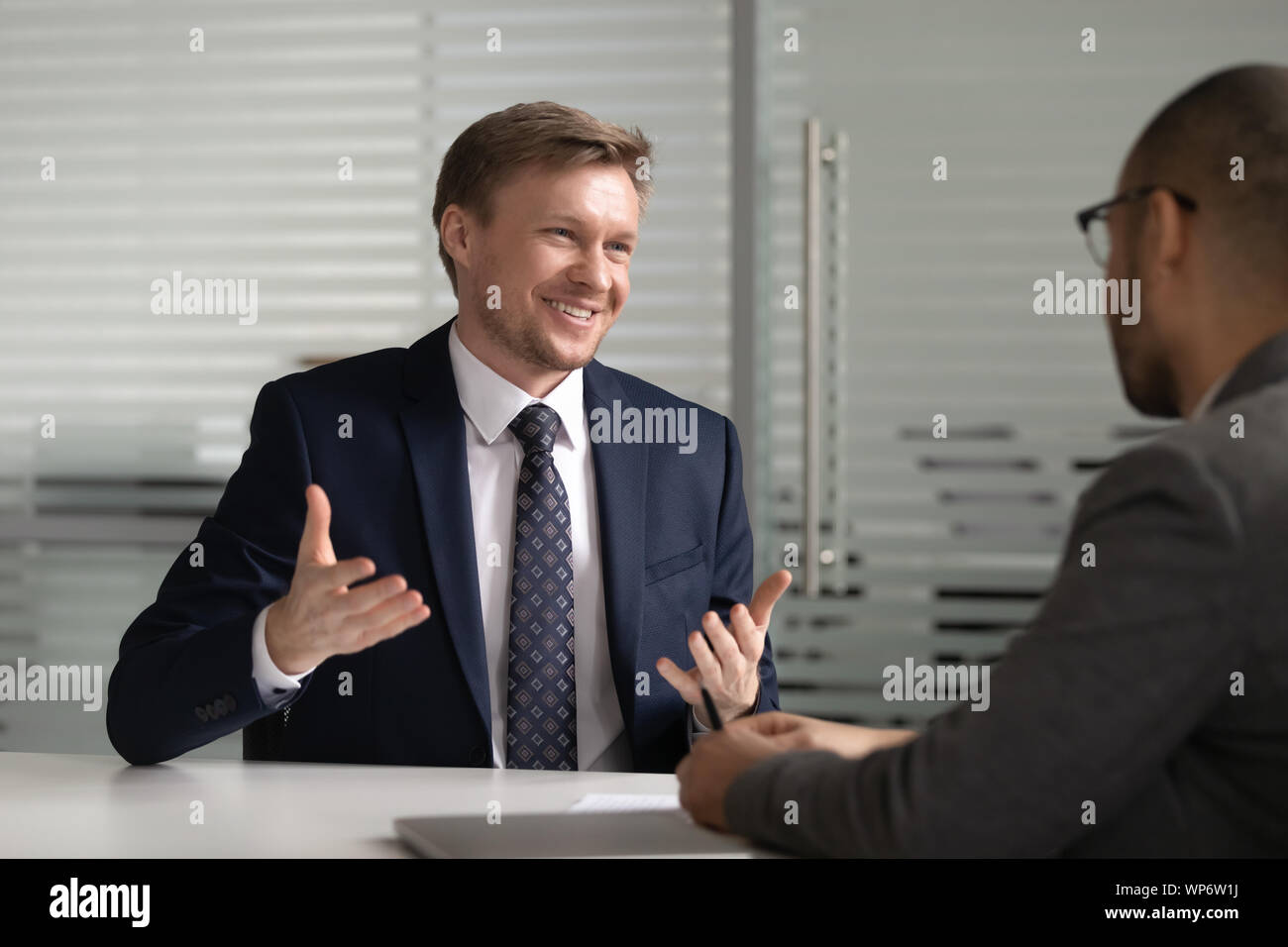 Cheerful ceo sharing company development ideas with partner Stock Photo ...