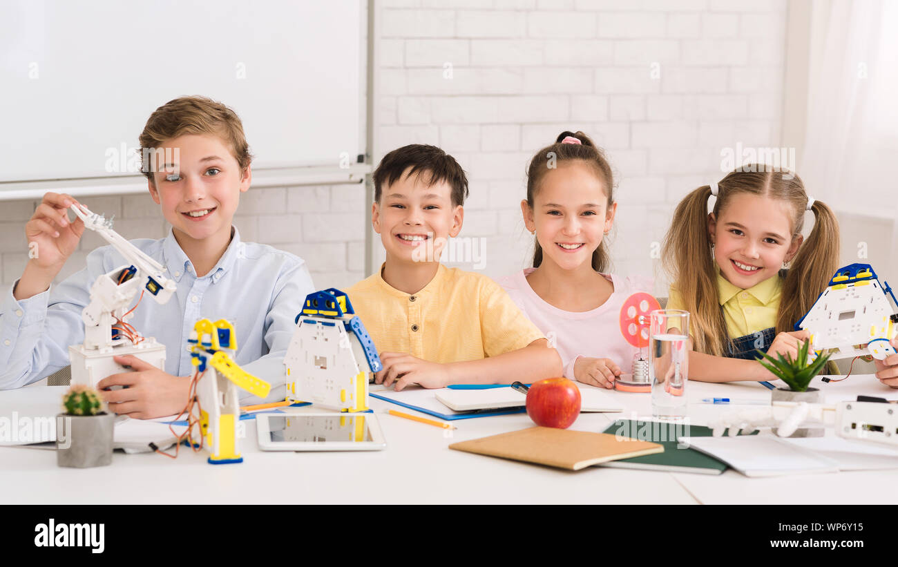 Stem education. Children creating robots at classroom Stock Photo - Alamy