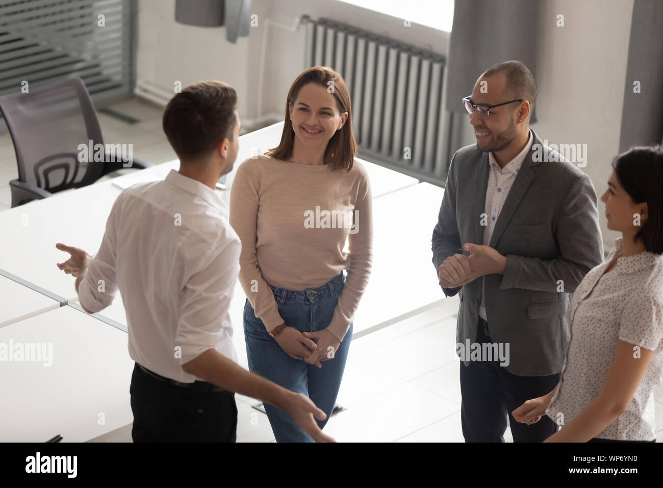 Confident team leader explaining work moments to employees Stock Photo ...