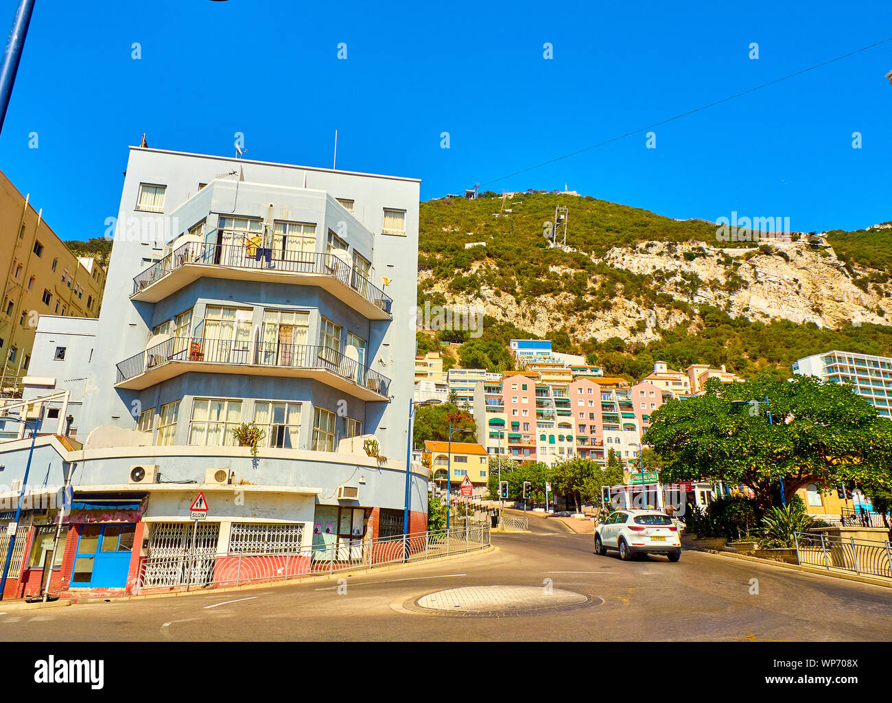 A typical street of Gibraltar with the Rock of Gibraltar in the ...