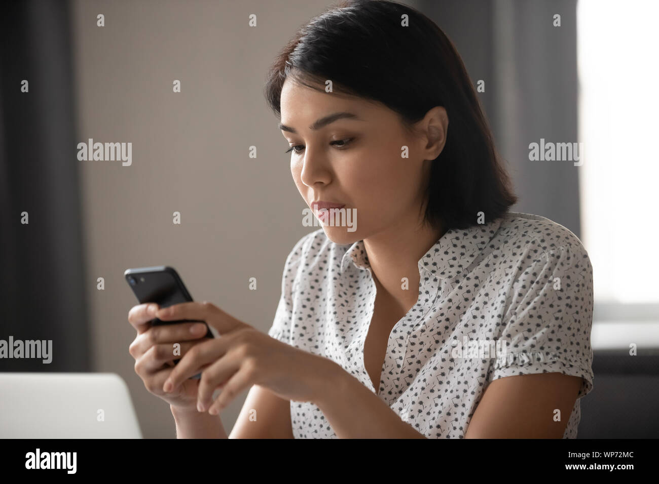 Concentrated asian japanese business woman texting message in cellphone ...