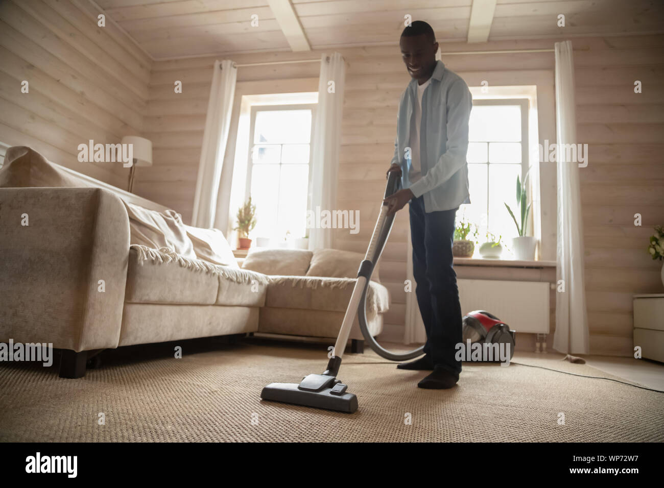 African American man use vacuum cleaner hovering house Stock Photo - Alamy