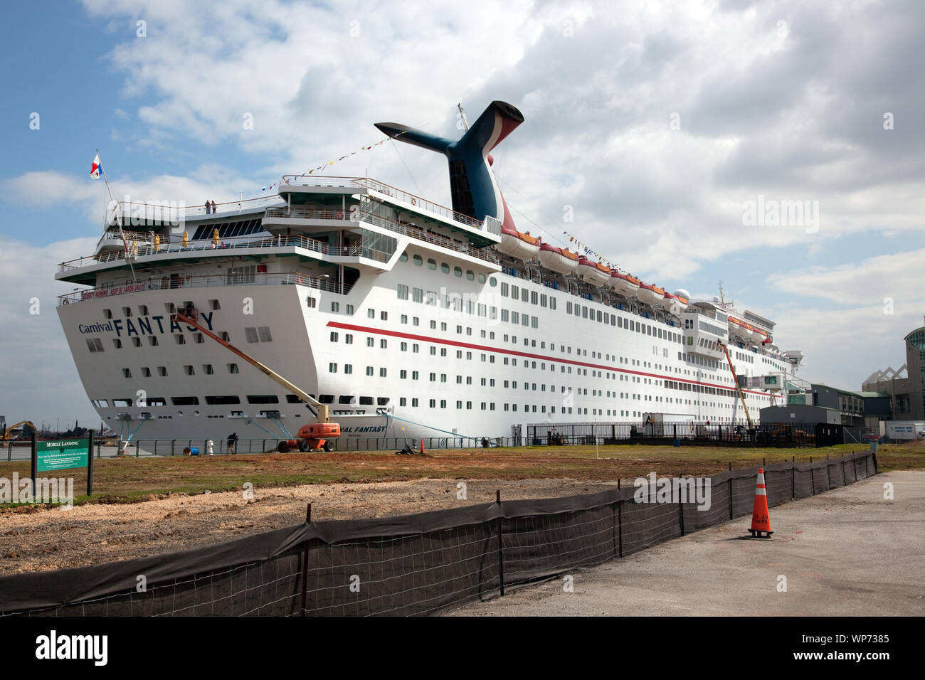 Large cruise ship picks up passengers at a loading dock a block away ...