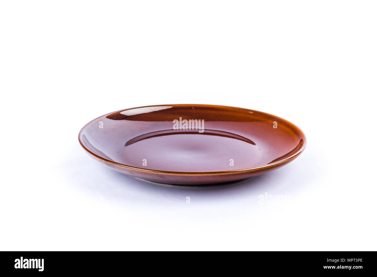 brown plate on a white background Stock Photo - Alamy