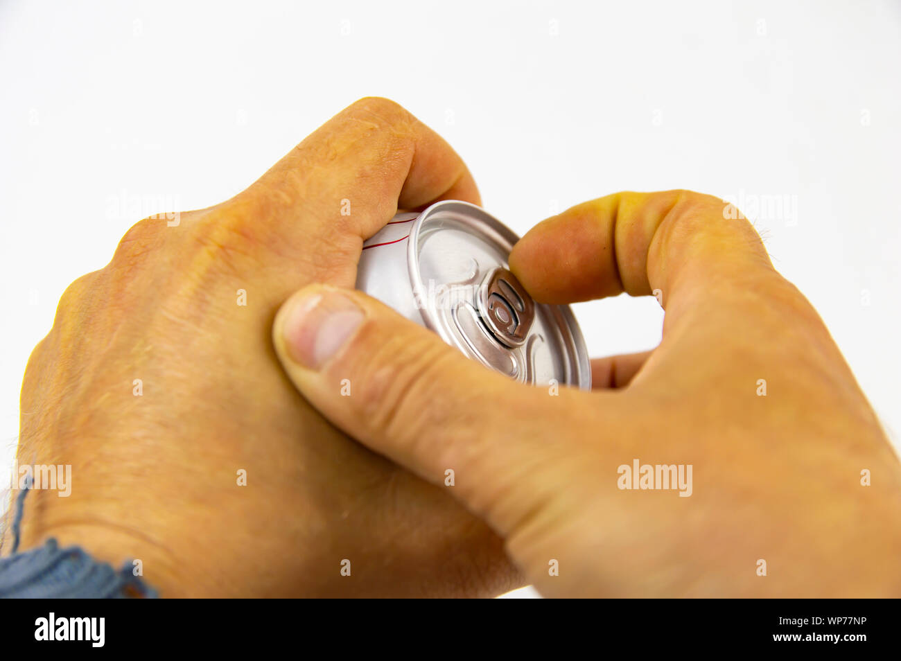 Aluminum can for drinks in the hands of a man on a white background ...