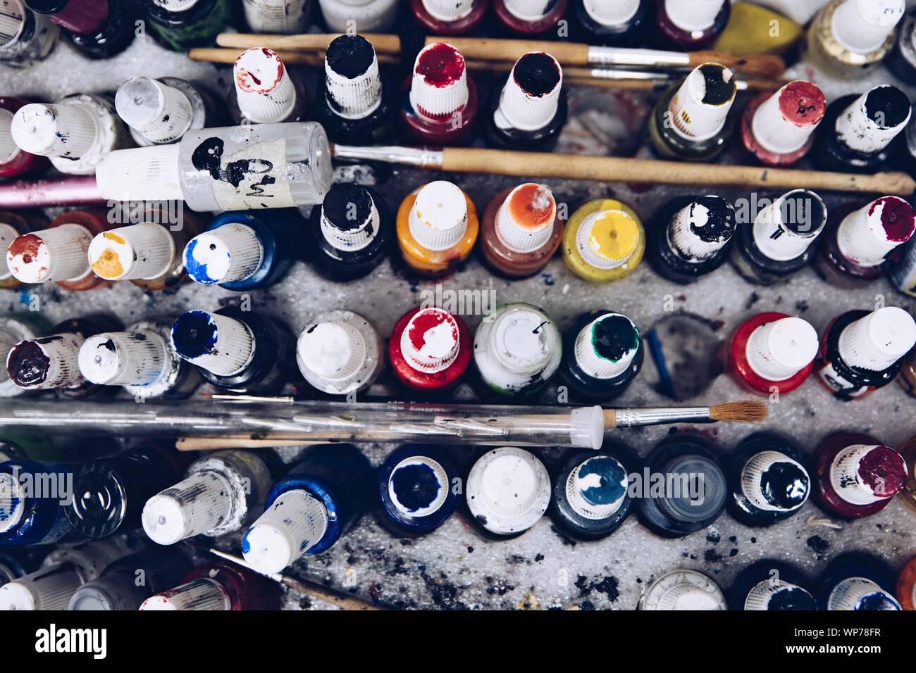 Dirty paint containers and brushes. Artist palette Stock Photo - Alamy
