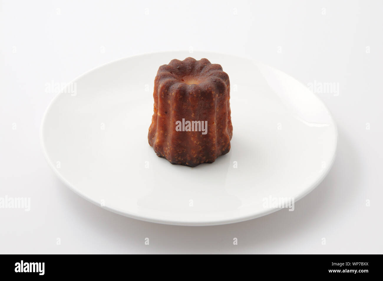 canele de Bordeaux french pastry on plate closeup isolated on white ...
