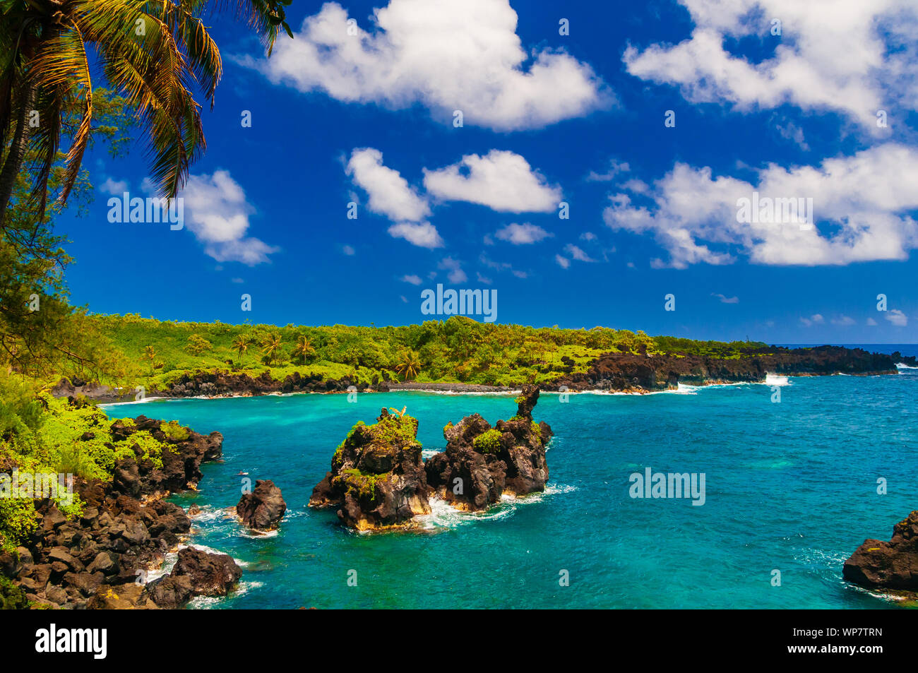 Waves breaking on the rocks on a sunny day during a spectacular ocean ...