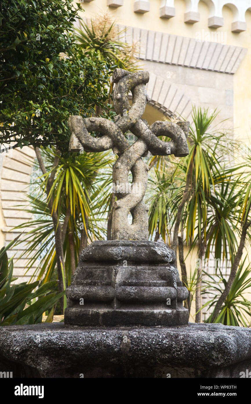 Stone "woven" cross on plinth in the entrance area to the 19th century ...