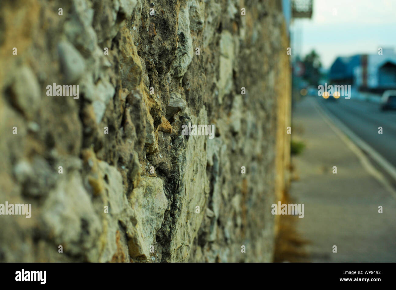 Perpendicular view of rocky wall of a Spanish's street. looking down ...