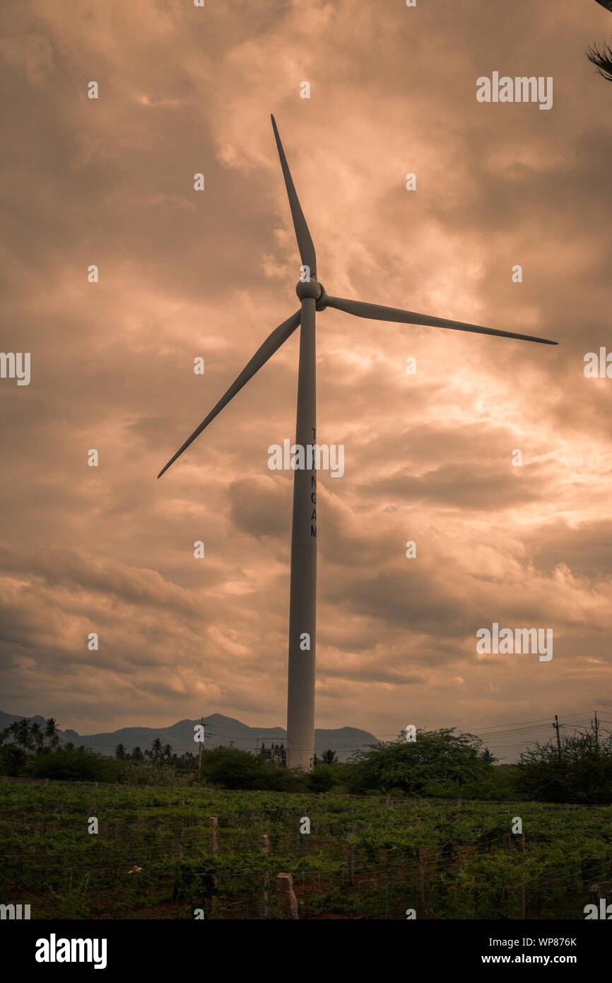 Huge windmill with dramatic sky with lots of clouds in the background ...