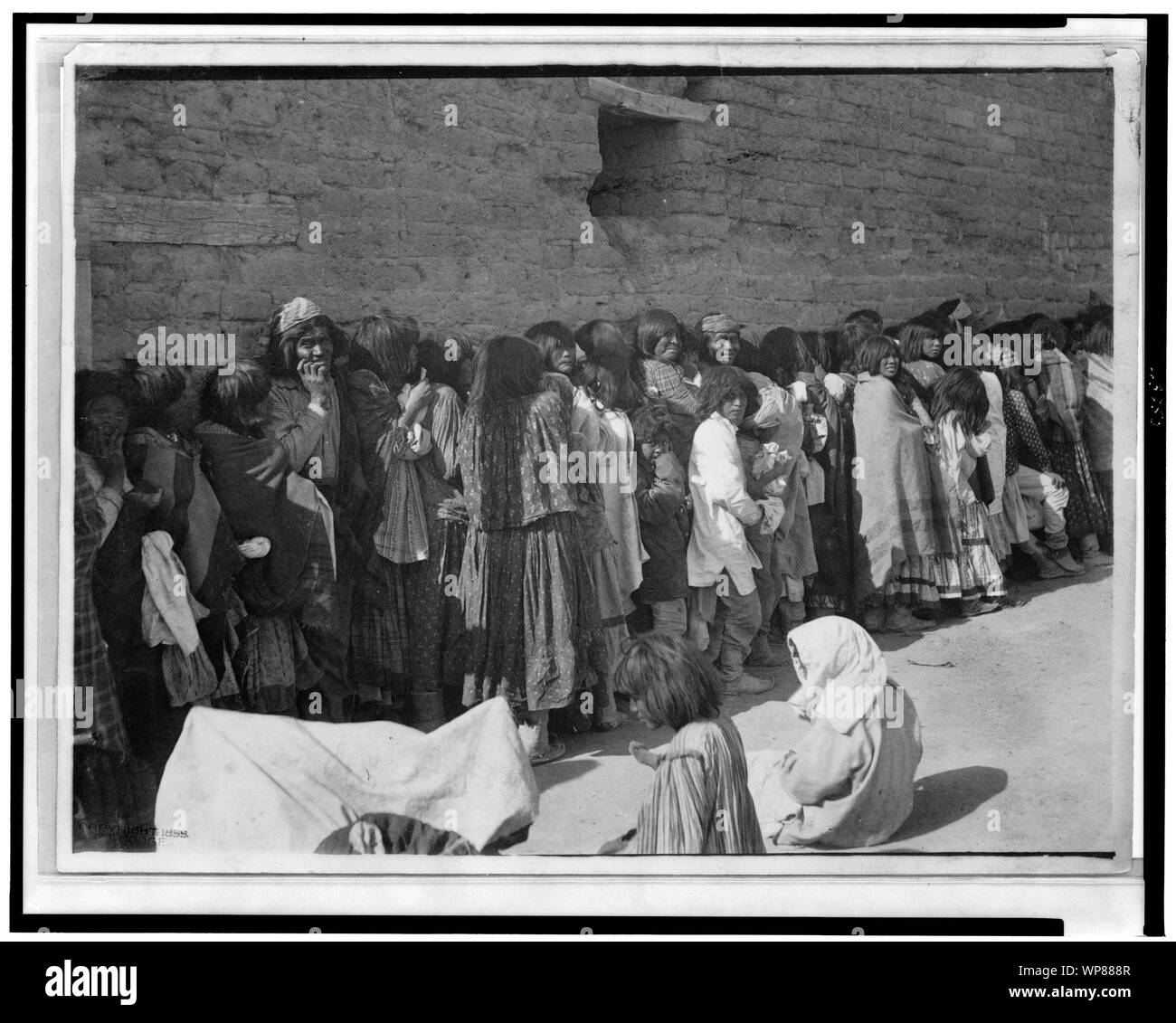 Line of Apache men, women, and children outside agency building on ...